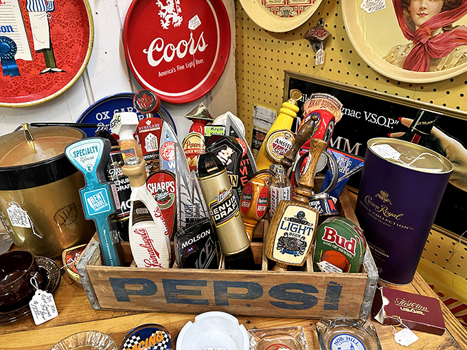 A wooden Pepsi crate brimming with vintage beer tap handles. The perfect conversation starter for your home bar or man cave.