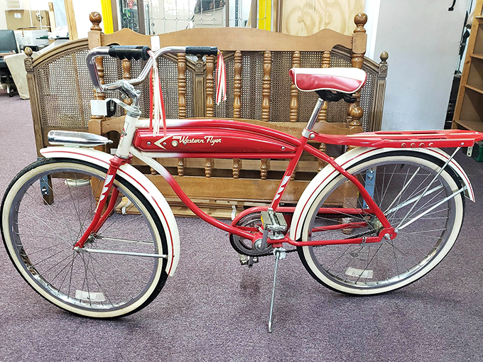 This cherry-red Western Flyer bicycle isn't just transportation; it's a time machine to simpler days of neighborhood adventures and skinned knees.