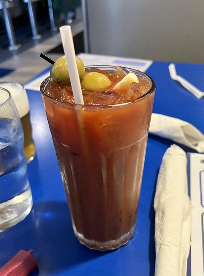 The Bloody Mary arrives like a liquid meal—garnished with enough pickled accessories to qualify as both beverage and appetizer.