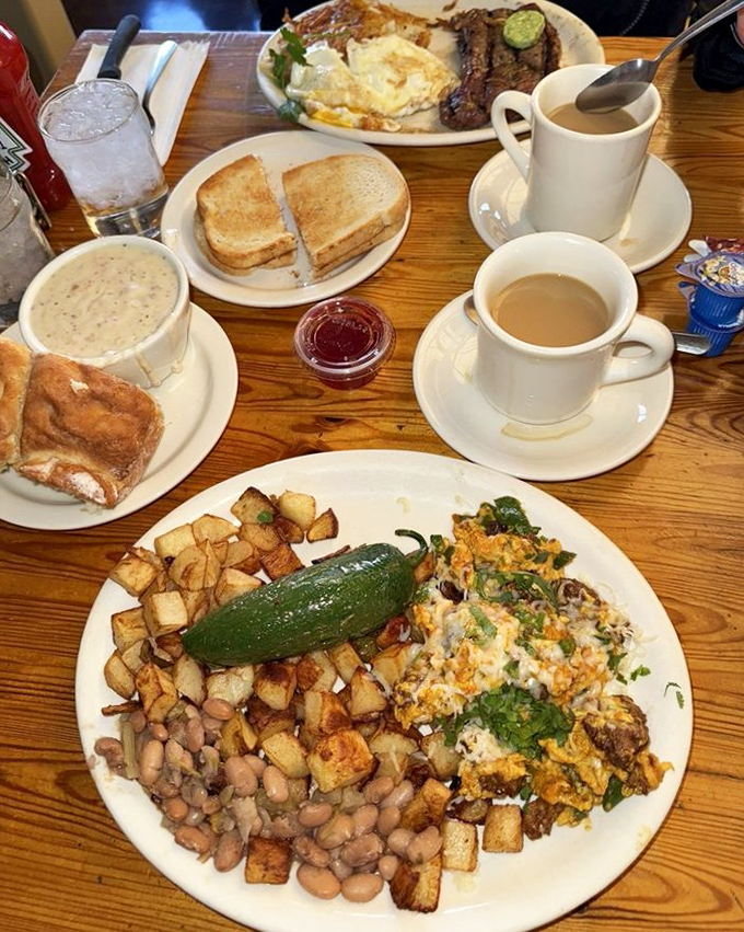 A table laden with breakfast bounty—toast, coffee, omelets, and potatoes—where every plate tells a different morning story.