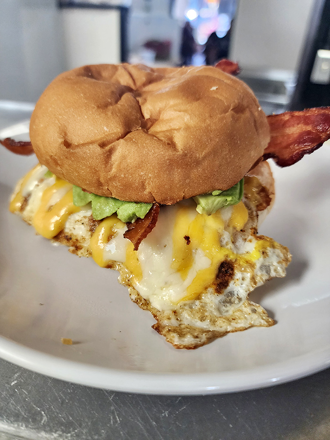 A breakfast sandwich that understands the importance of proper architecture &ndash; egg, cheese, bacon, and avocado in golden-ratio perfection.
