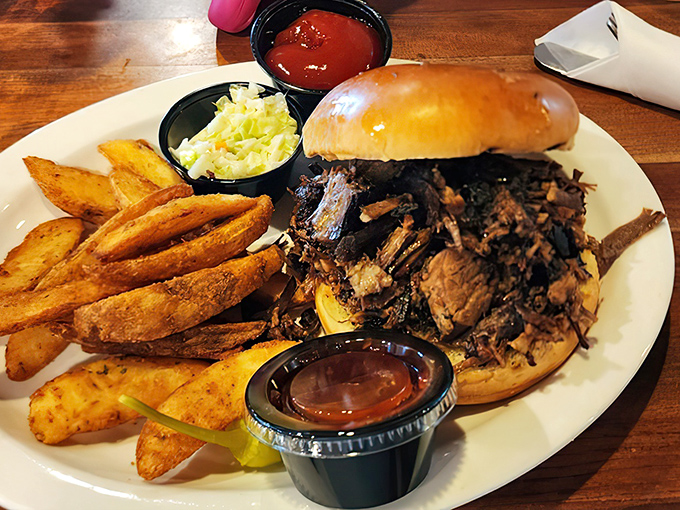 The pulled pork sandwich in its natural habitat &ndash; surrounded by golden fries and coleslaw that actually deserves to be eaten.