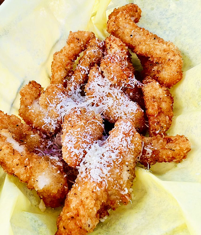 Calamari strips that crunch louder than your aunt's new leather couch. Perfectly golden and ready for their close-up.