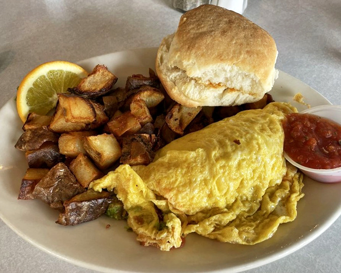This omelet doesn't just contain ingredients; it showcases them&mdash;a supporting cast of home fries and biscuit complete the ensemble.