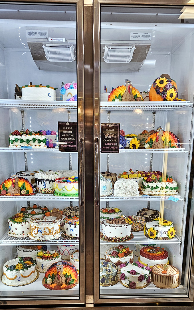 Custom cakes behind glass, each one a masterpiece that belongs in the Louvre's dessert wing.