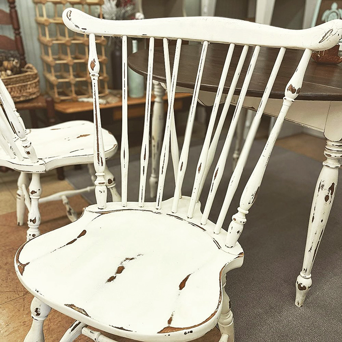 That distressed white chair isn't just furniture; it's a time machine waiting to transport you back to Sunday dinners at grandma's farmhouse table.