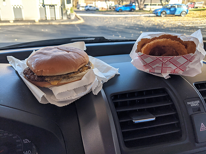 The classic burger and onion ring combo, displayed on the dashboard altar. Some people pray in churches; others worship at the temple of perfect simplicity.