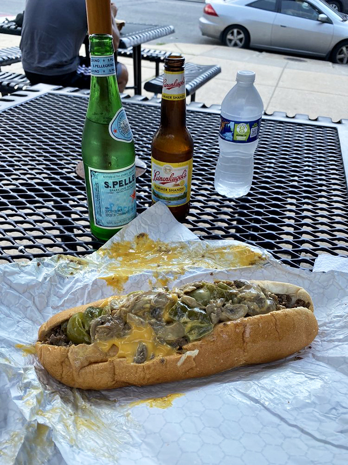 The perfect Philly trifecta: sparkling water, beer, and a cheesesteak with mushrooms and peppers. Dining doesn't get more civilized.