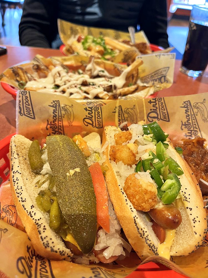 A pickle spear standing tall like the Emerald City next to what might be the most perfectly constructed tater tot dog in the Midwest.