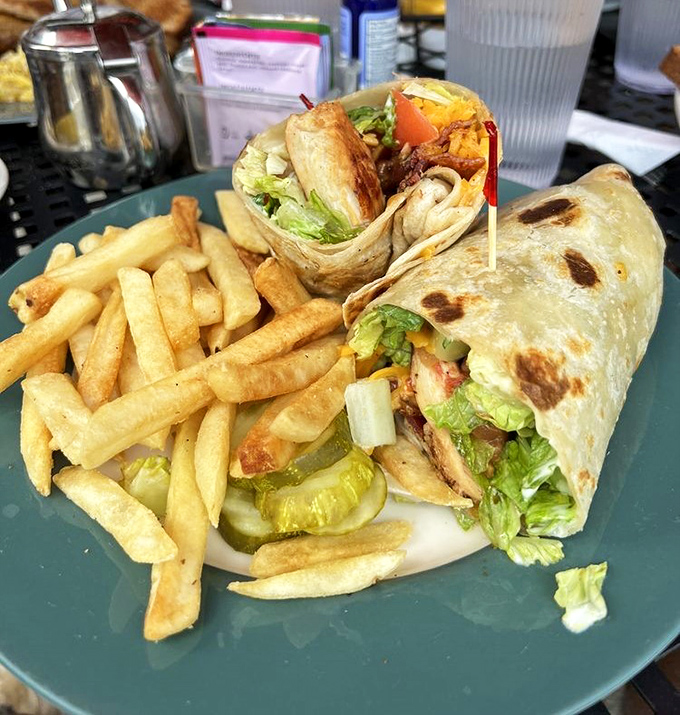 This wrap isn't messing around &ndash; packed tighter than a suitcase before vacation with fresh veggies and protein, with fries standing by for moral support.