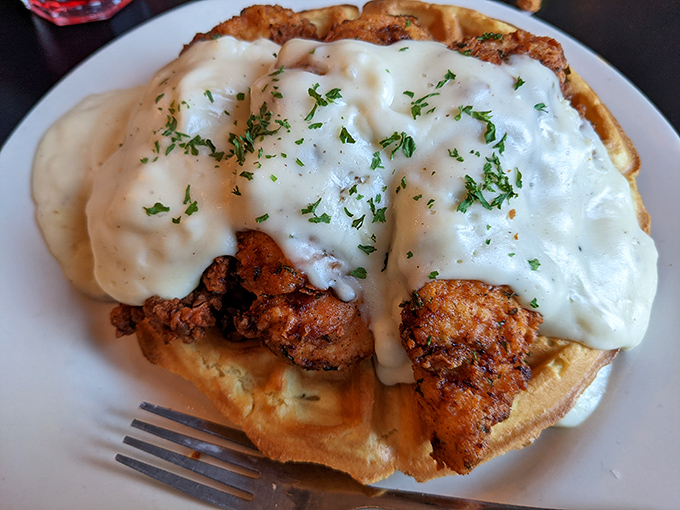 Chicken and waffles drowning in gravy – breakfast meets dinner in this heavenly collision.