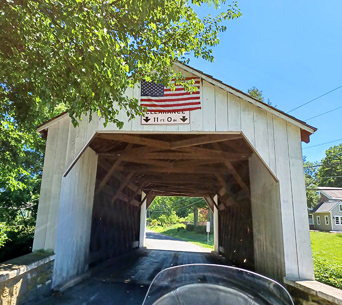 The bridge's classic white entrance with its clearance warning serves as both practical information and a portal to Pennsylvania's transportation history.