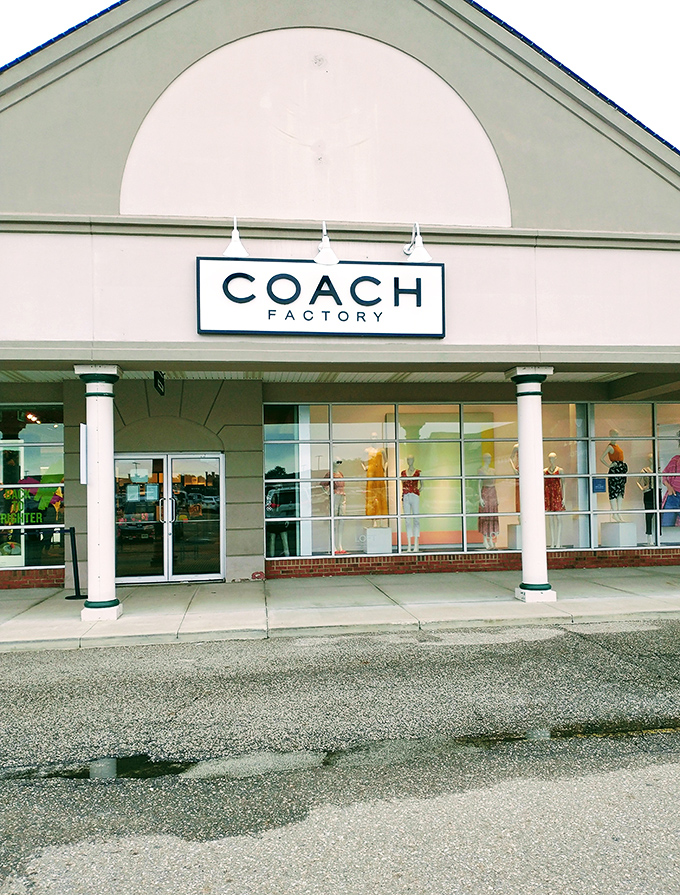 The Coach Factory store stands like a beacon of hope for luxury lovers on a budget. That iconic logo has never looked so approachable.