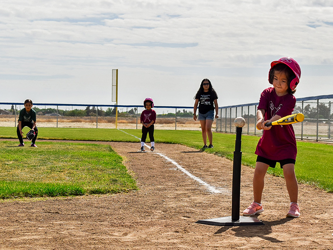 T-ball in the park – where future MLB stars (or just happy kids) learn America's pastime under the watchful eyes of patient parents.