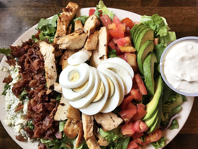 A Cobb salad that proves vegetables can play nice with bacon and eggs, creating a colorful landscape of flavors across the plate.