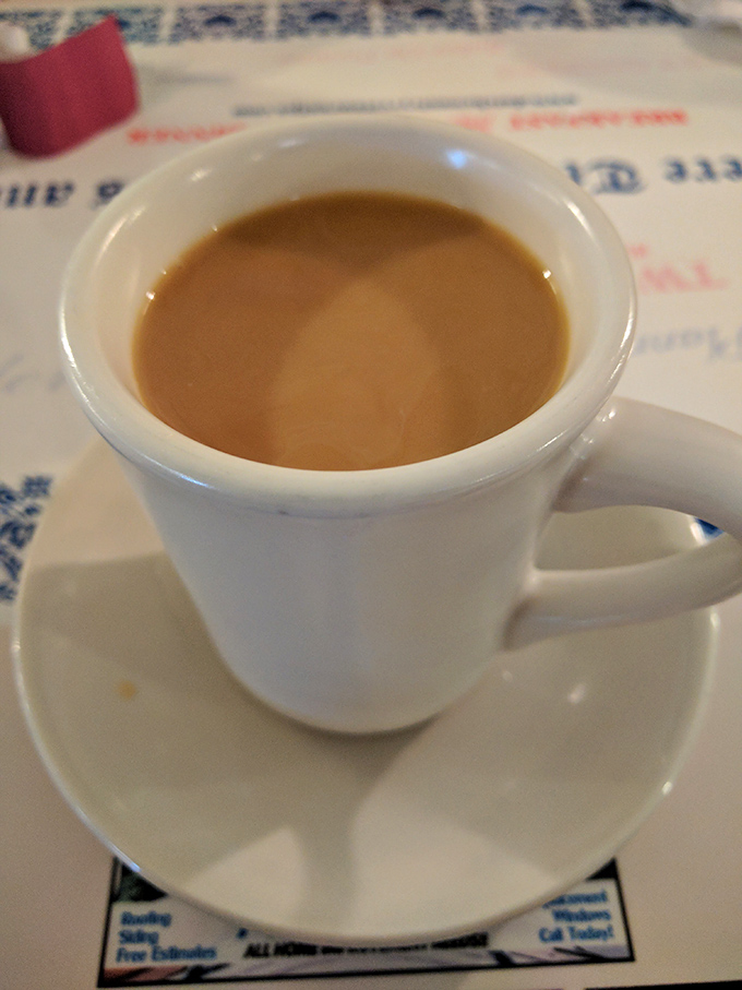 Coffee in a sturdy white mug&mdash;no fancy latte art, no pretentious pour-over ritual, just honest caffeine delivered with refill-ready efficiency.