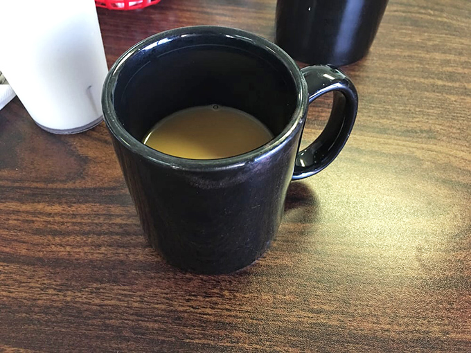 The humble coffee mug – unassuming vessel for the life-giving elixir that makes morning conversations possible and breakfast complete.