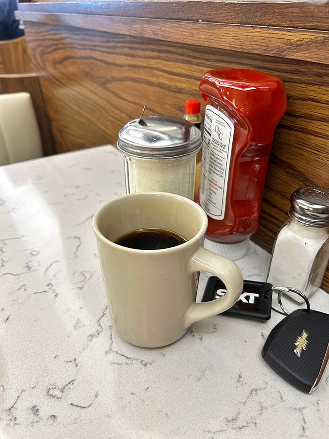 The classic diner coffee setup&mdash;where important decisions and casual gossip have equal weight. That mug has heard some stories.