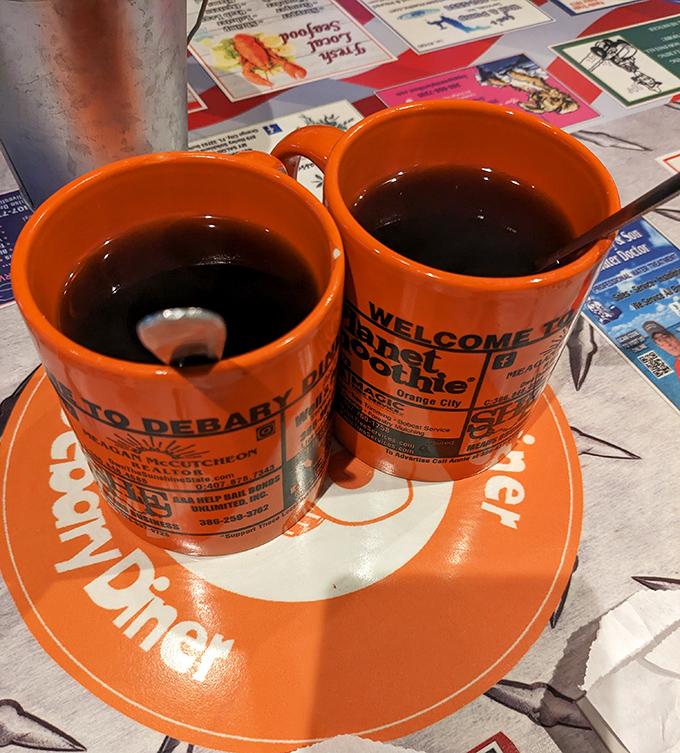 Coffee served in cheerful orange mugs that somehow make Monday mornings feel manageable.