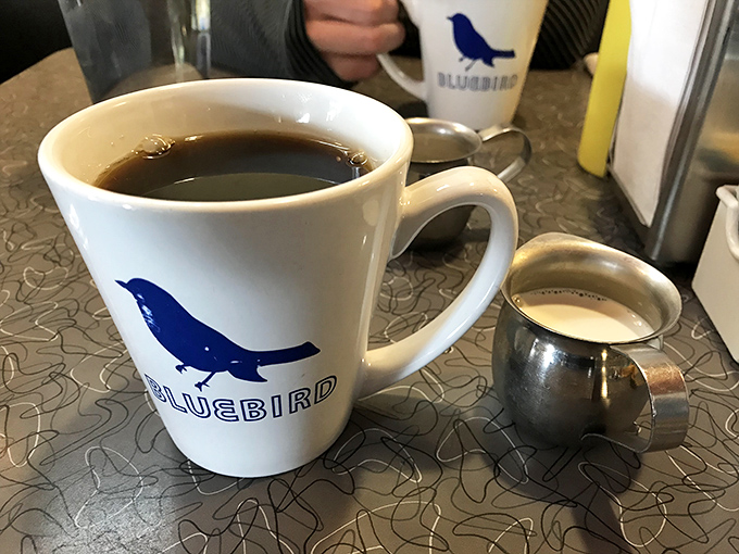The coffee mug's blue bird isn't just a logo&mdash;it's a promise that your morning blues will fly away after the first sip.