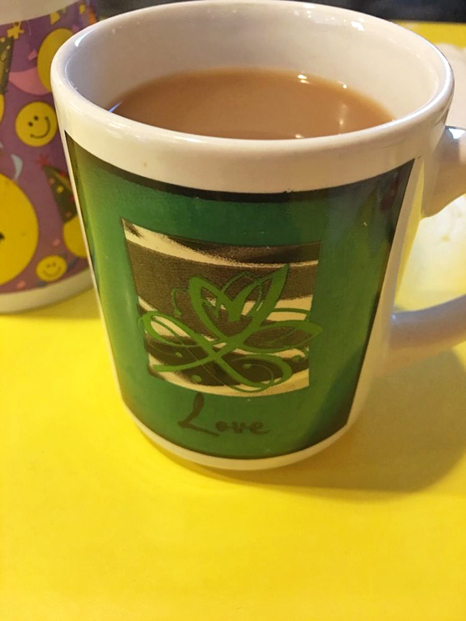 A cheerful mug of coffee on a sunny yellow table. Some mornings are just better with a side of optimism and unlimited refills.