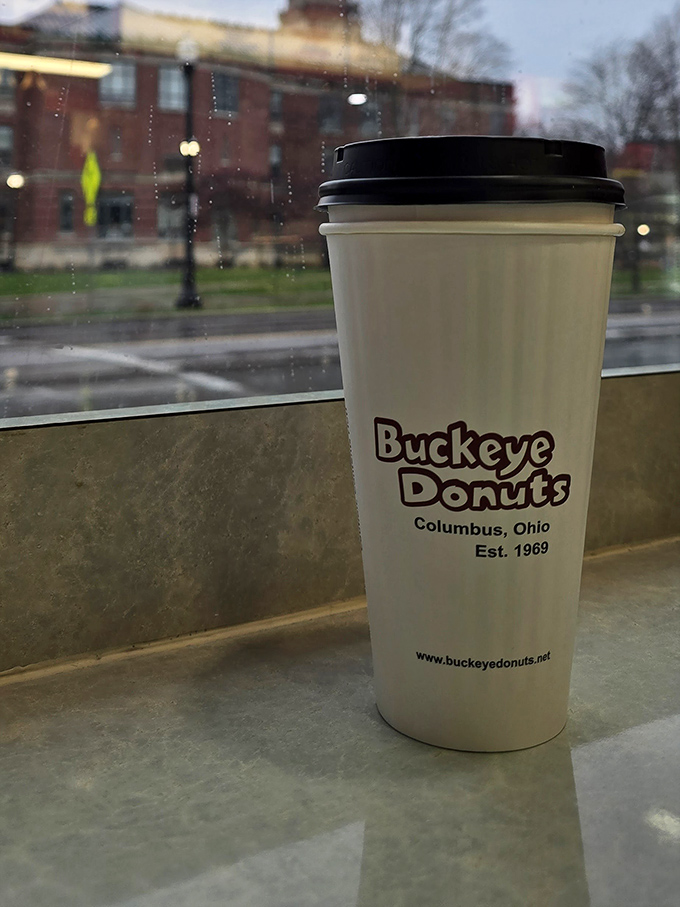 The window to campus life, one sip at a time. This branded cup has probably fueled more all-nighters than the university would care to admit.