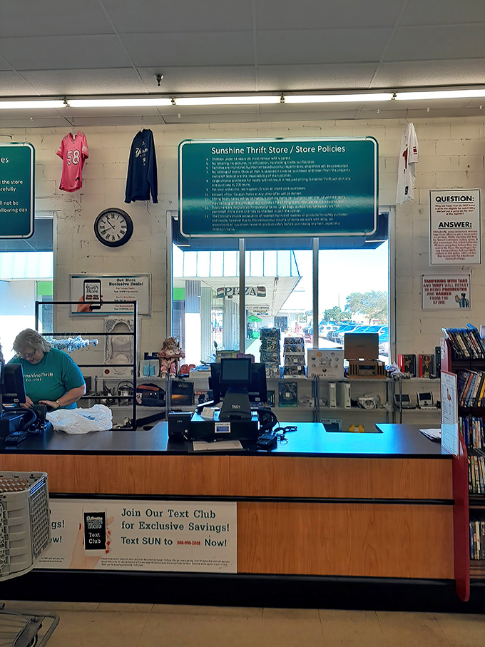 The checkout counter&mdash;final gateway between thrift store treasures and your home. That text club sign promises even more savings for the truly committed.