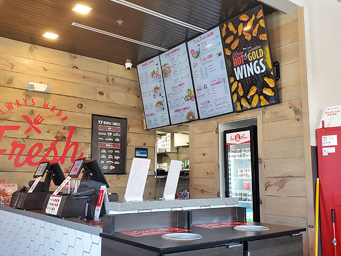 Behind wooden panels and hexagonal tile, culinary magic happens&mdash;the ordering counter where chicken dreams begin their journey to reality.