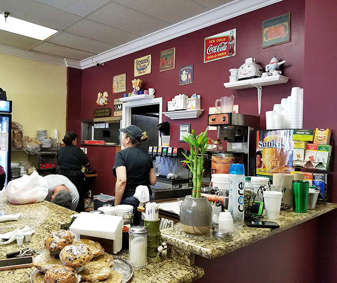 Behind the counter, where breakfast magic happens. The vintage collectibles and classic signs aren't manufactured nostalgia—they're artifacts from a genuine American diner tradition.