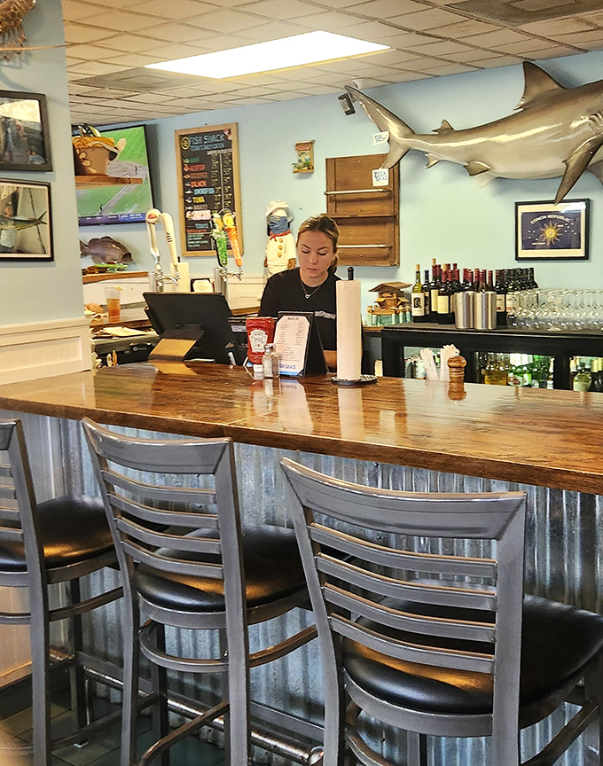 The bar area, where fishing tales grow taller with each round, and the only thing fresher than the seafood is the conversation.