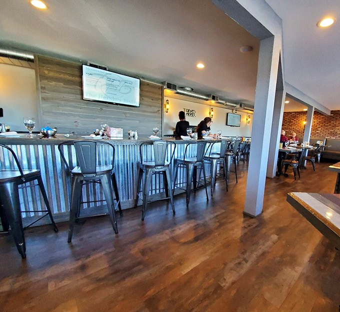 The bar area invites lingering conversations and impromptu friendships. Those metal chairs may look industrial, but they've witnessed countless celebrations and confessions.