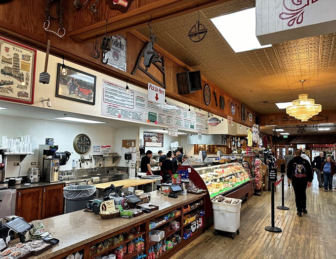 The deli counter stretches endlessly, showcasing more cured meats and cheeses than most people see in a lifetime.