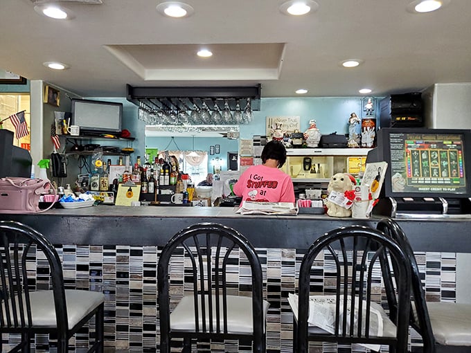 Behind the counter, where breakfast magic happens. The tilework adds a touch of diner authenticity that can't be manufactured.