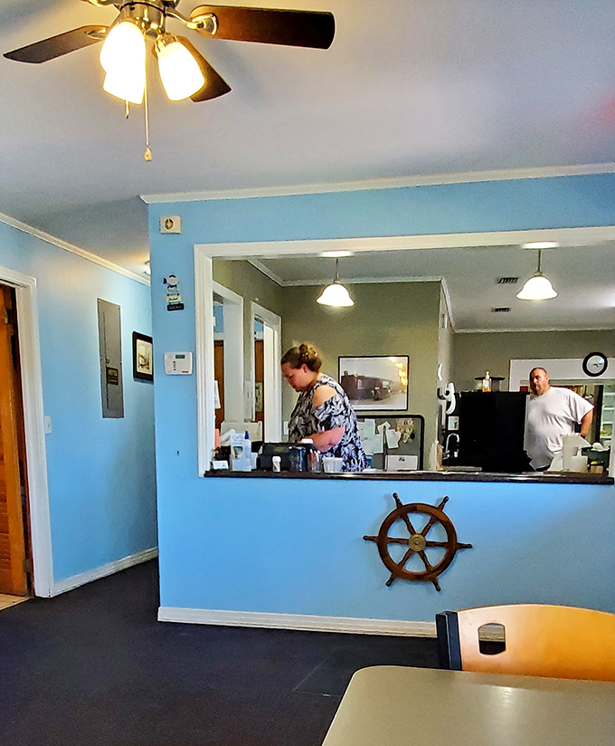 The blue reception counter with its ship's wheel isn't trying to be nautical-cute&mdash;it's just acknowledging where your dinner came from. Respect the source.