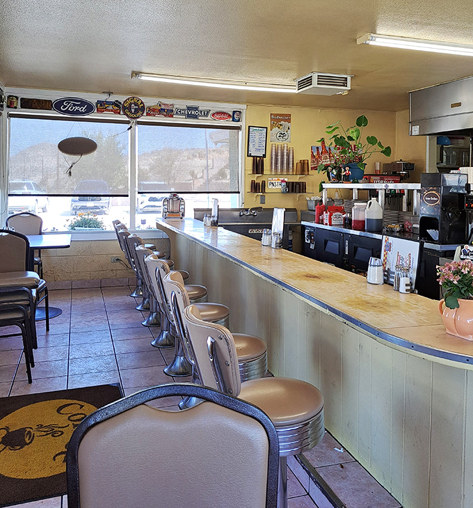 The counter where magic happens &ndash; chrome stools await hungry patrons while vintage signs remind you that good diners never really change.