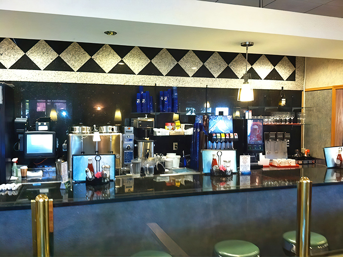 The gleaming counter where coffee dreams come true. That black and white diamond pattern? Pure diner royalty watching over breakfast subjects.