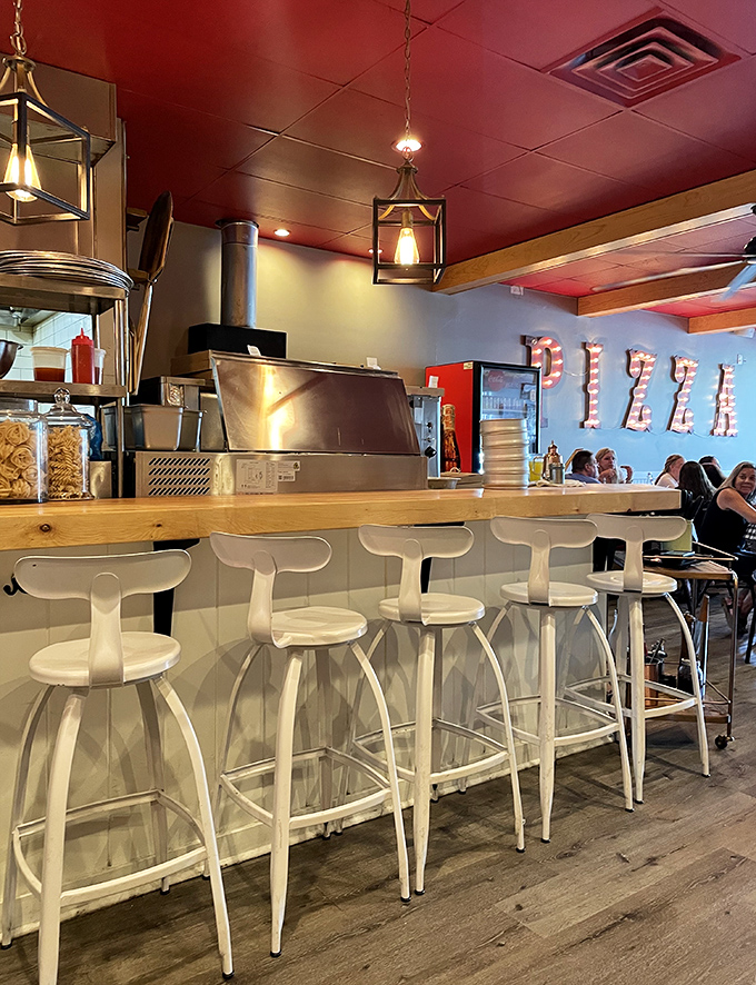 Modern white stools at a wooden counter where culinary magic happens. The hanging lights add just the right touch of drama.