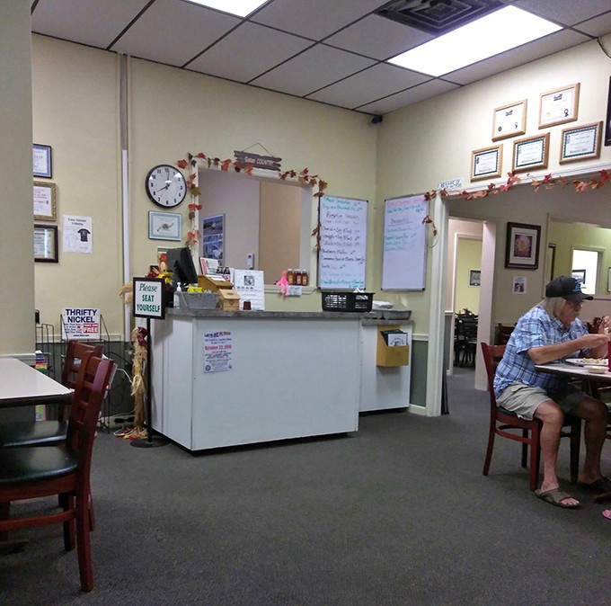 The counter area—where solo diners become regulars and regulars become family. Notice the whiteboard specials, always worth investigating.