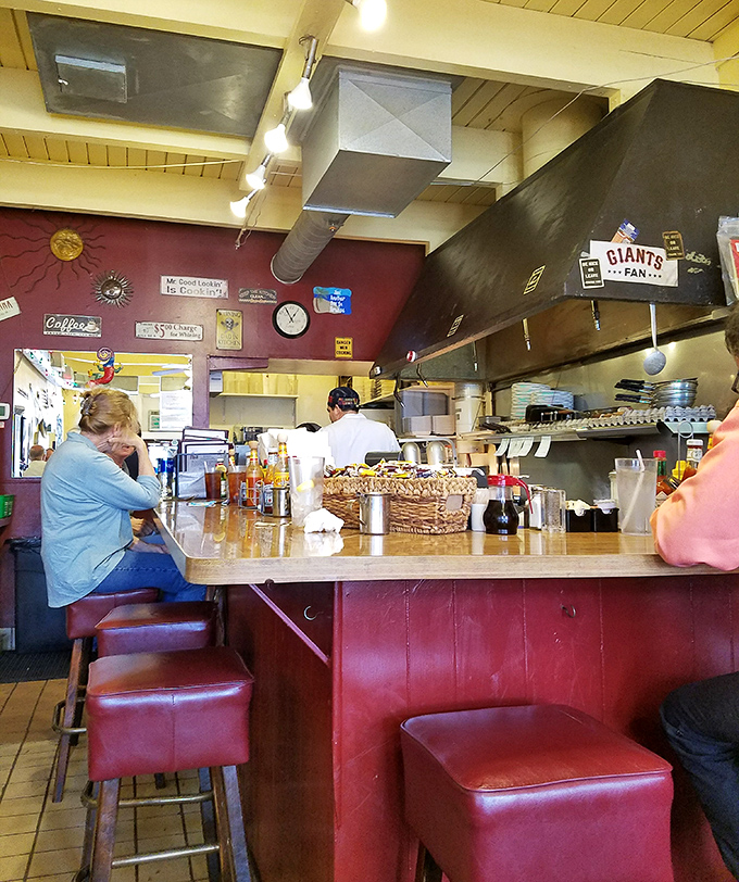 The counter offers front-row seats to the breakfast show, where red stools invite you to perch and watch kitchen choreography in action.