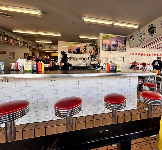 The classic diner counter, where strangers become friends united by the universal language of great burgers.