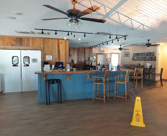 The bar area combines coastal blue with natural wood elements&mdash;like the ocean meeting the shore in an interior design love story.