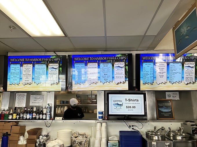 The ordering counter reveals the organized chaos of a busy seafood joint, where digital menus and friendly staff keep the ocean's bounty flowing to hungry patrons.
