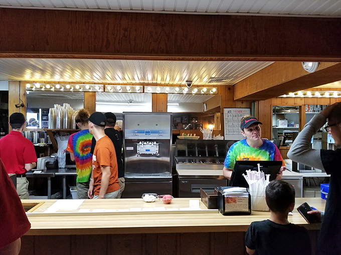 The counter where dreams come true – young staff in tie-dye shirts orchestrating the ice cream magic that's made Ivanhoes a destination for decades.