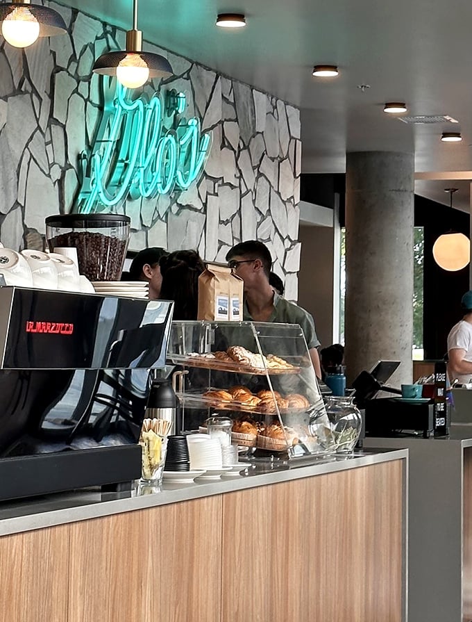 The neon Glo's sign against stone wall creates a breakfast beacon that says, "Yes, this is where the hollandaise magic happens" to everyone who enters.