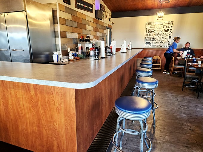 Counter seats where regulars solve world problems between bites of biscuits and sips of sweet tea.
