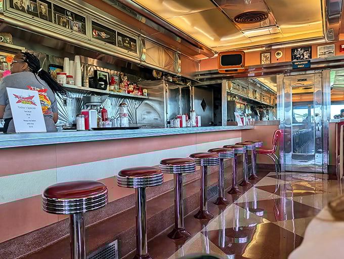 Those chrome-trimmed counter stools aren't just seats—they're front-row tickets to the greatest show in town: breakfast made with skill and served with a smile.