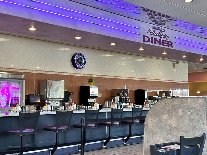 The purple-accented interior creates that rare dining atmosphere where both 7am business meetings and post-church family gatherings feel equally at home.