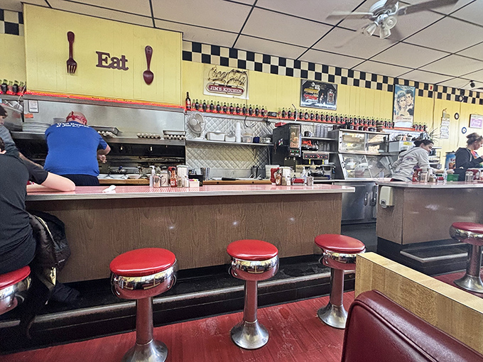 The command center of comfort food, where the simple wooden sign reading "Eat" might be the most unnecessary instruction ever posted in a restaurant. 