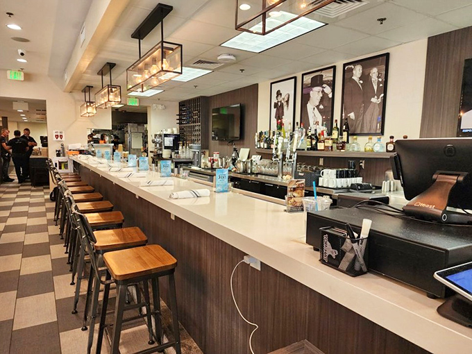 The counter where magic happens and strangers become friends. Those vintage photos on the wall are silently judging your sandwich choice.