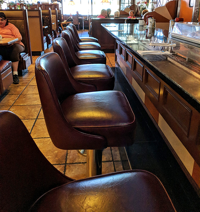 Counter seats lined up like front-row tickets to the greatest show on earth: breakfast being made with theatrical flair.